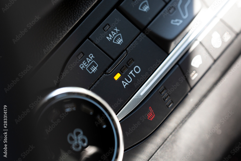 Auto button switch on a modern car. Button for air condition and rear ...