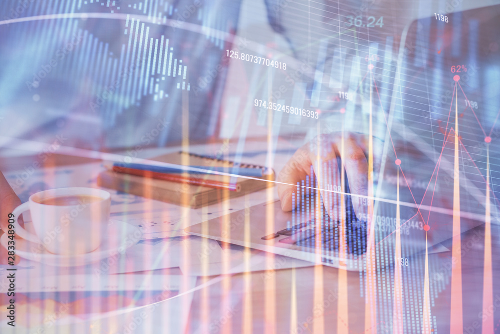 Forex graph with businessman working on computer in office on ...