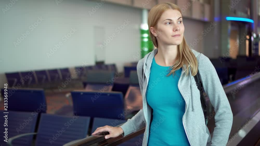 Video „Beautiful attractive woman in airport terminal. Waiting for her ...