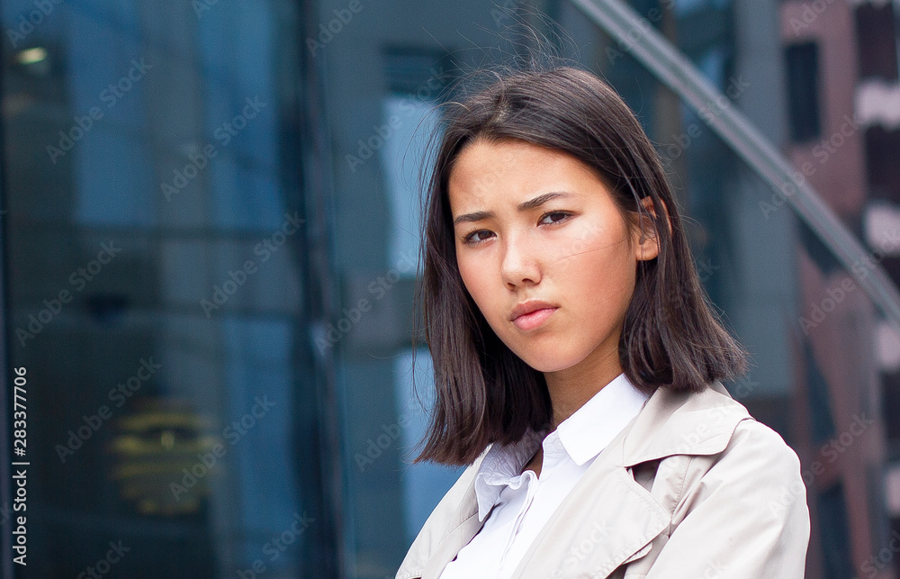 Angry dissatisfied asian girl or young businesswoman in formal clothes ...