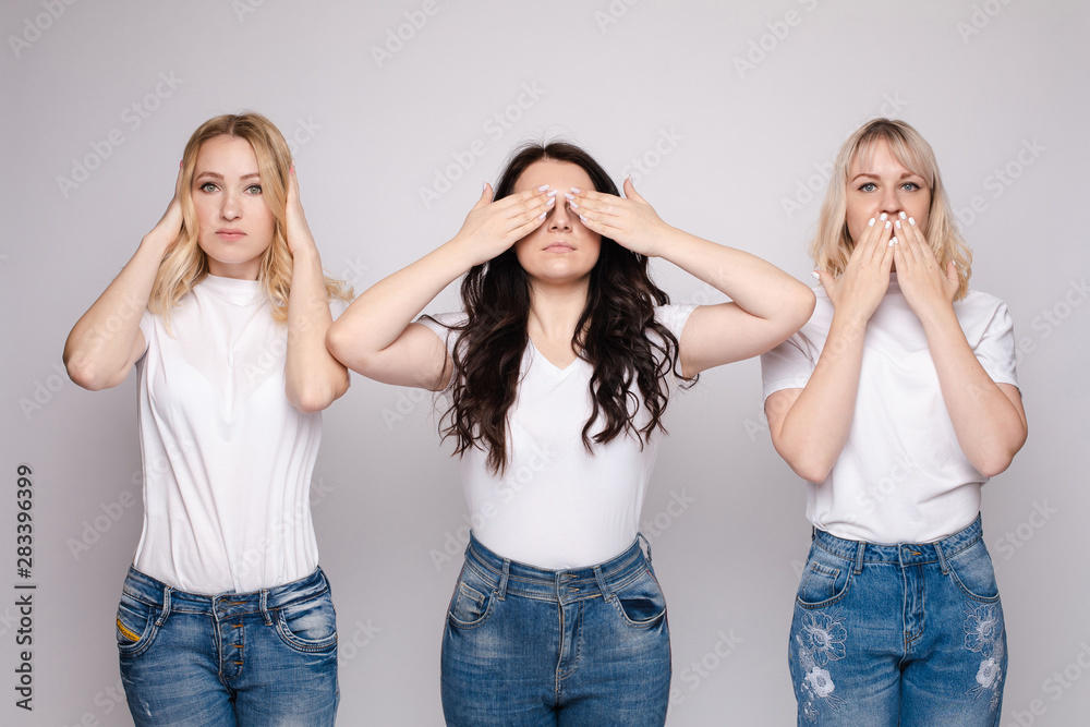 Crop of three young girls in casual clothes posing at camera. Women in ...