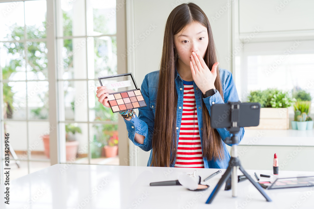 Beautiful Asian influencer woman recording make up tutorial using ...