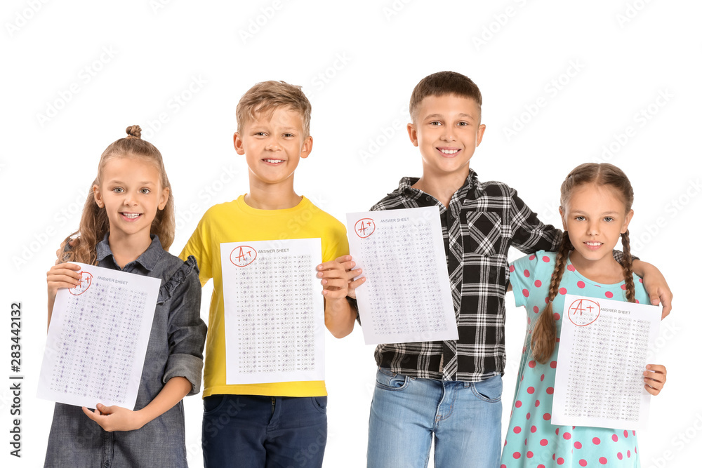 Happy children with answer sheets for school test on white background ...