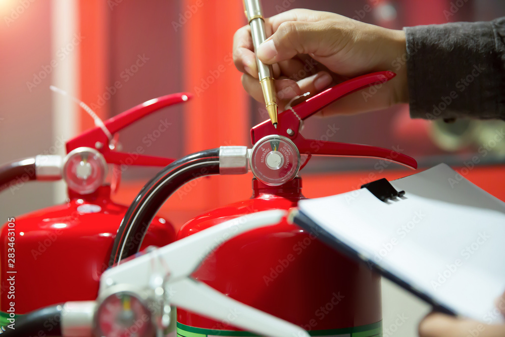 Fire extinguishers, Engineers are checking fire extinguishers. Stock ...