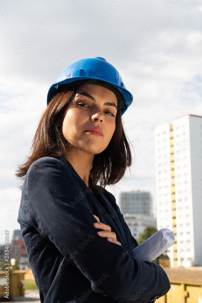 Portrait of a beautiful and successful lady architect wearing a blue ...