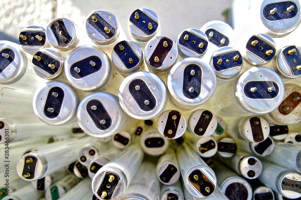 large amount of spent old fluorescent lamp tubes about to be recycled ...