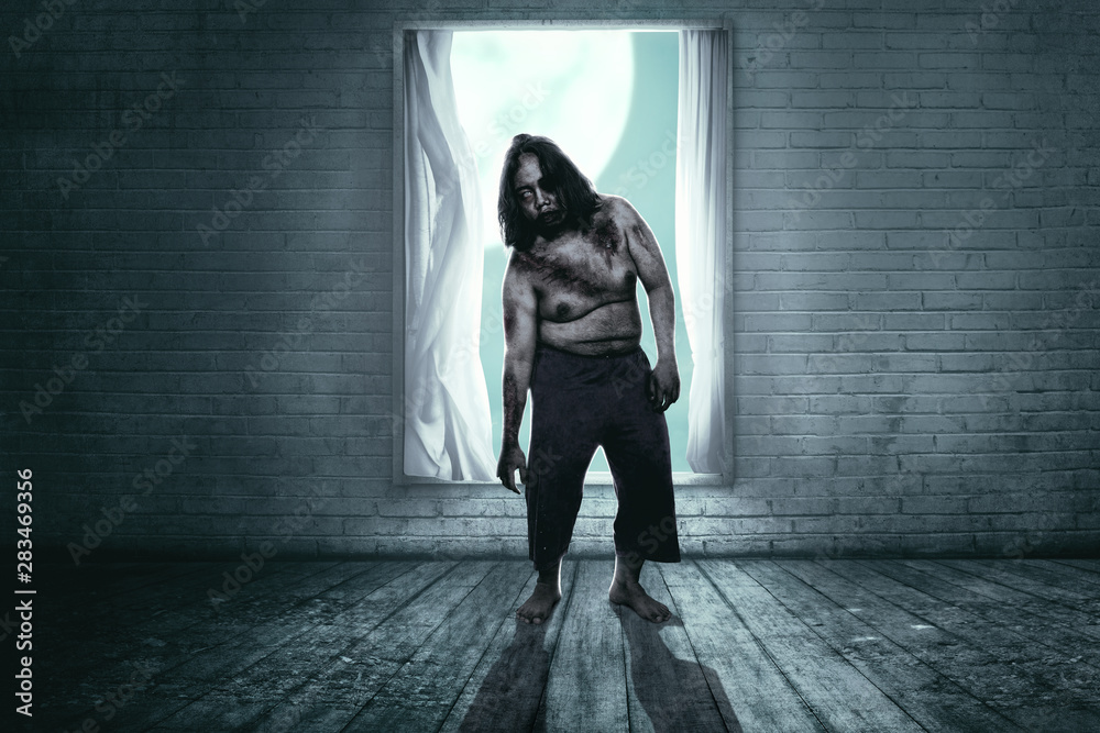 Scary zombies with blood and wound on his body haunted the abandoned ...