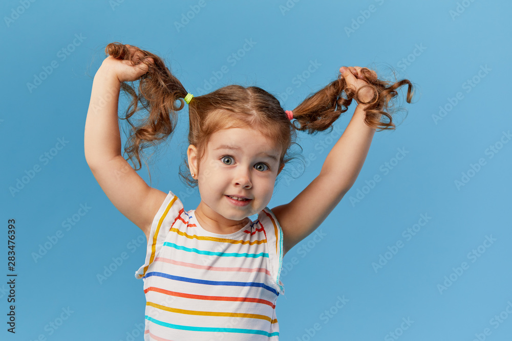 Portrait of surprised smiling cute little toddler girl. child standing ...
