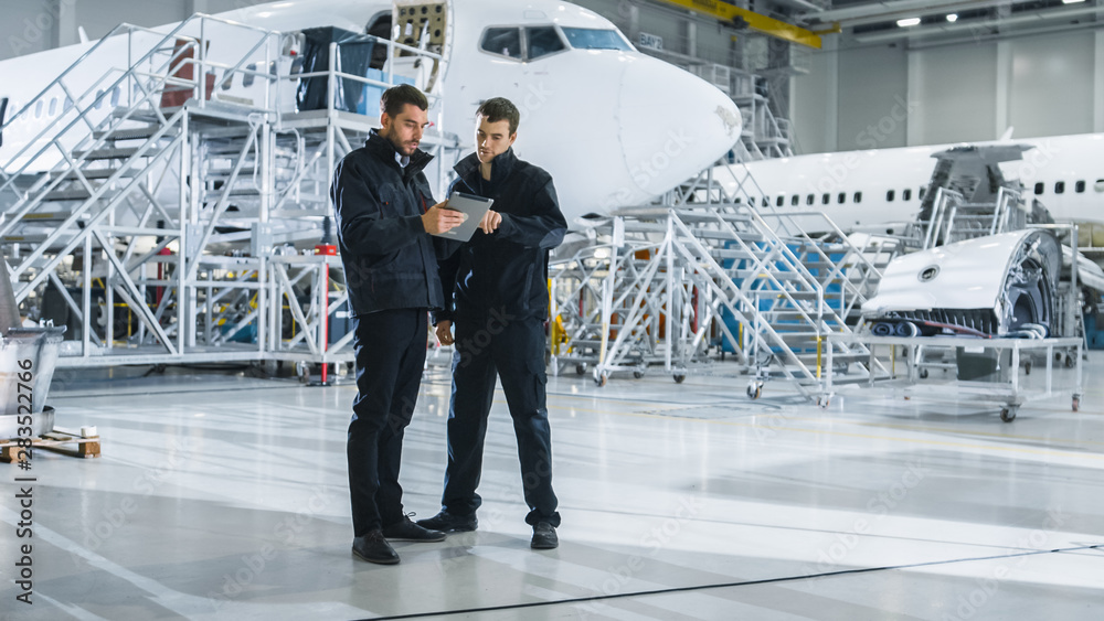 Team of Aircraft Maintenance Mechanics Looking at Airplane Stock Photo ...