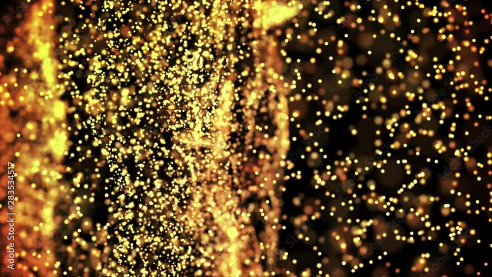 gold shiny sparkling particles move in a viscous liquid. It is bright ...