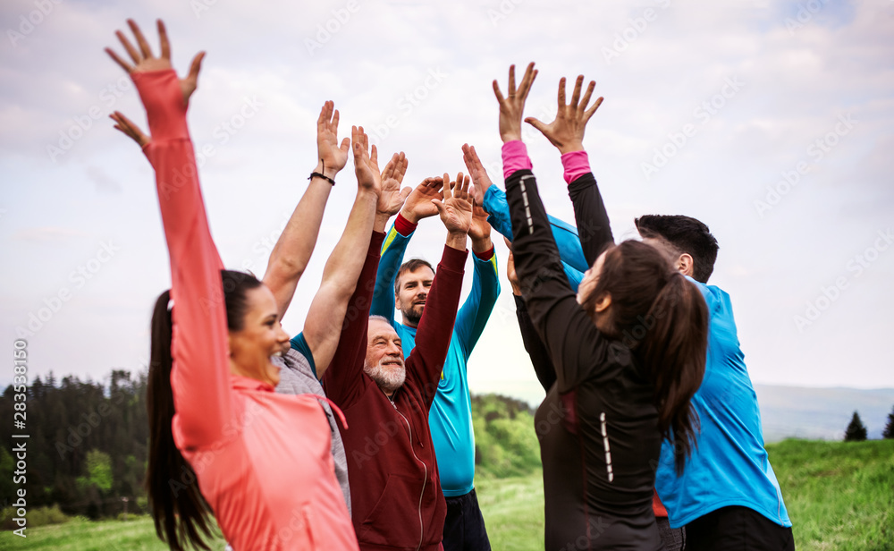 Large group of fit and active people resting after doing exercise in ...