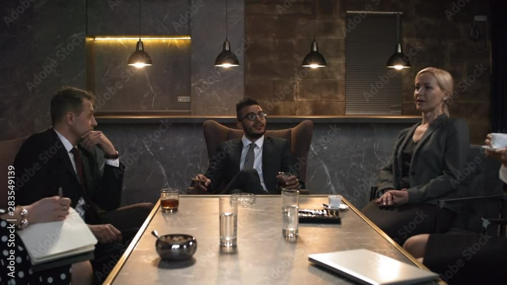 Dollying medium shot of male and female corporate executives in ...