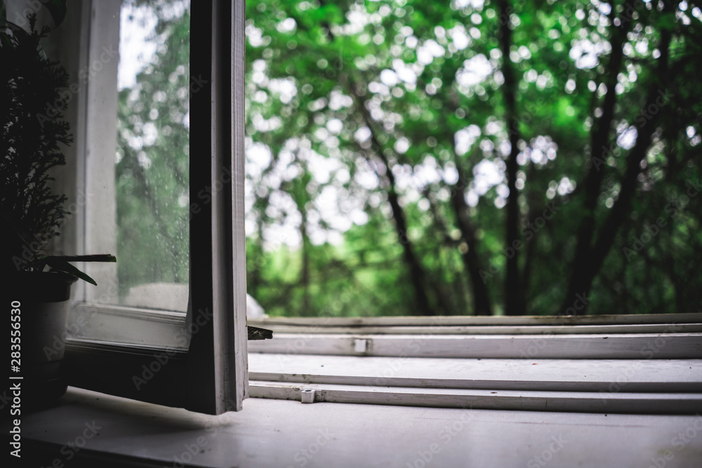 nostalgic concept, opened window in cozy walm home while it rains ...