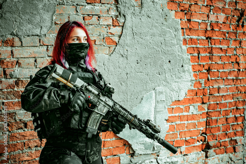Airsoft soldier red-hair woman in uniform with machine gun inside ...