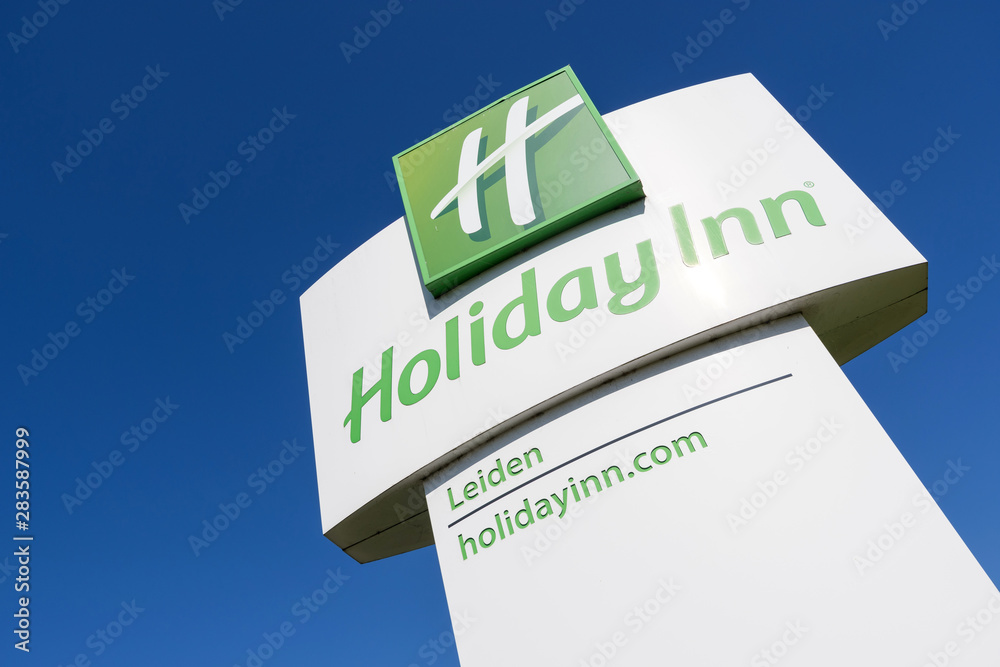 LEIDEN, THE NETHERLANDS - JUNE 27, 2019: Holiday Inn Hotel sign against ...