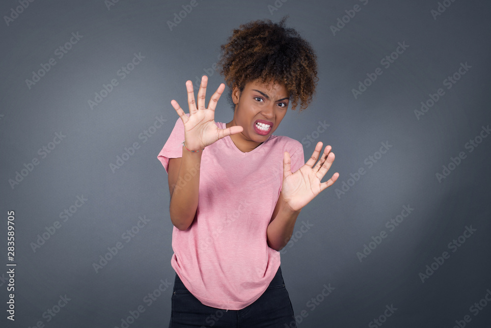 Dissatisfied female model frowns face, has disgusting expression, shows ...