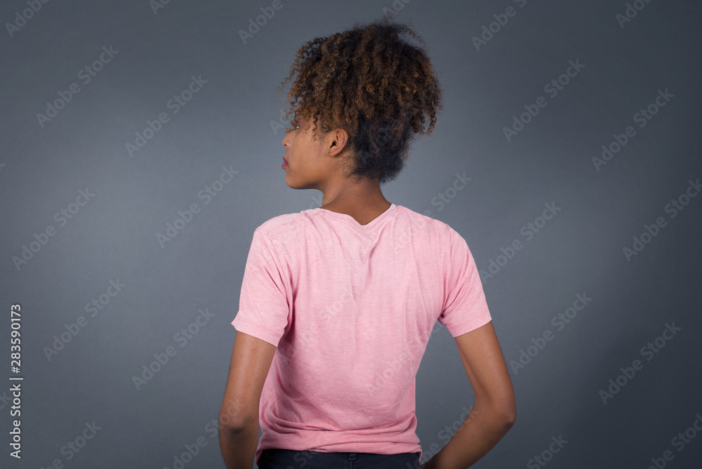 The back side view of an African American girl with curly and afro ...