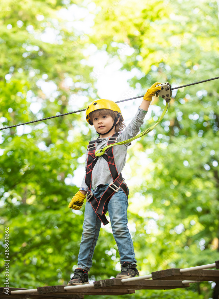 Child boy having fun at adventure park. Carefree childhood. Child ...