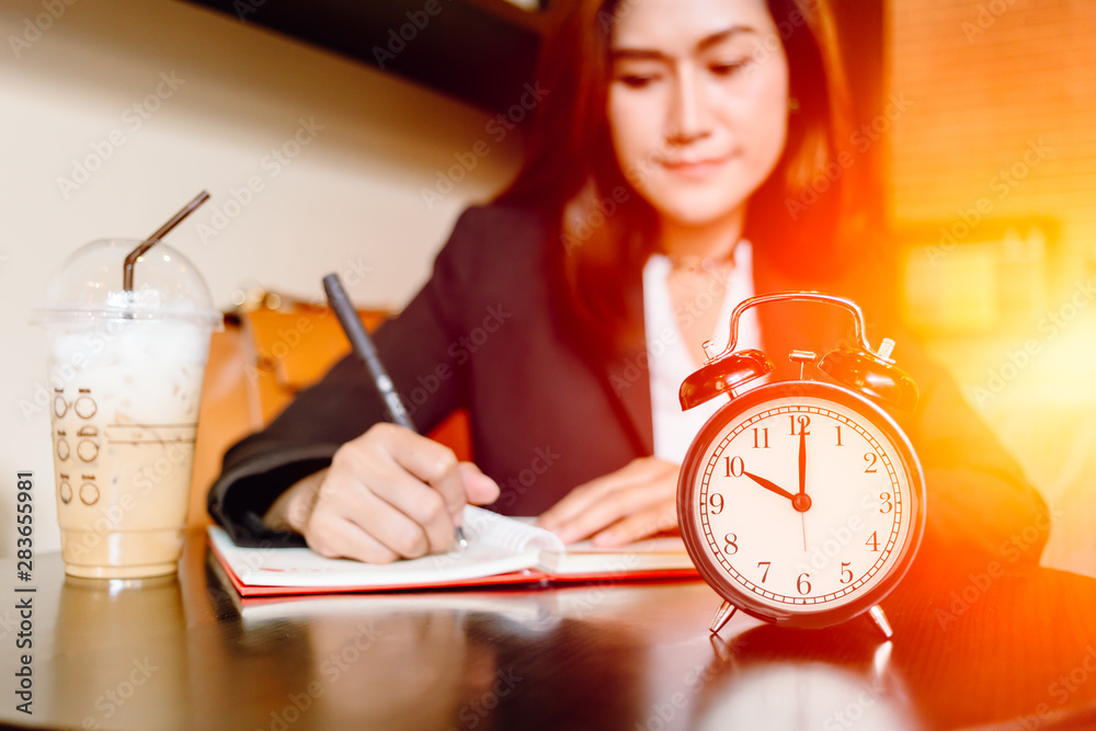 Asian Business girl working hours in cafe with time clock and coffee ...