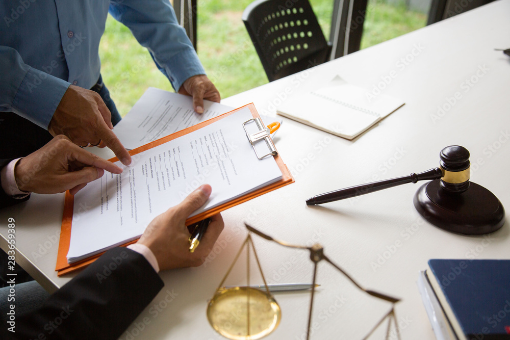 The lawyer is explaining the principles of law for people who come to ...