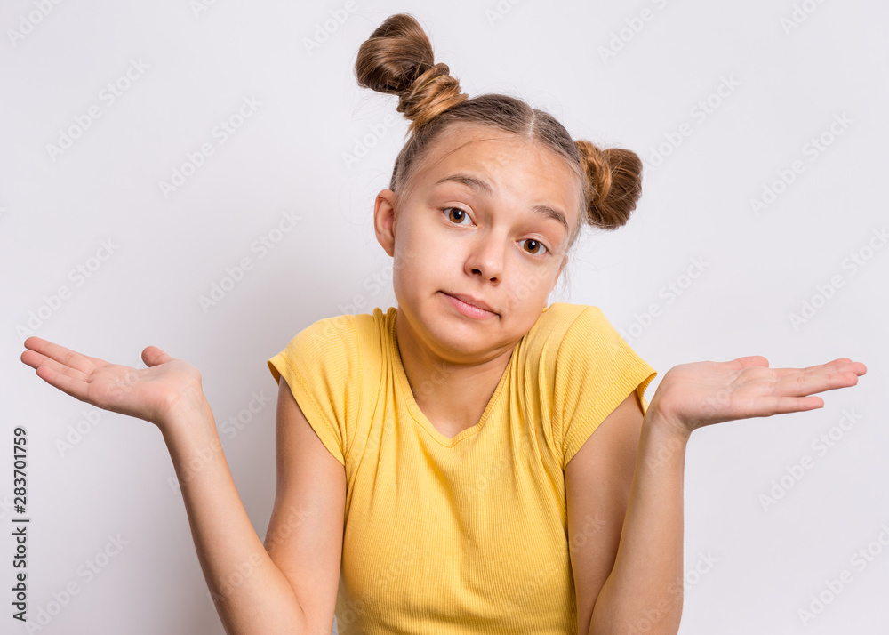 Portrait of teen girl showing helpless gesture with arm and hands - I ...