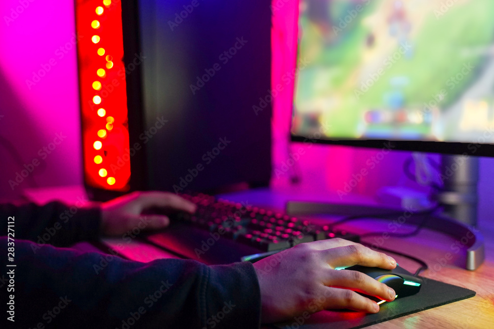 Hand on the mouse. Gamer concentrated using computer for the best ...