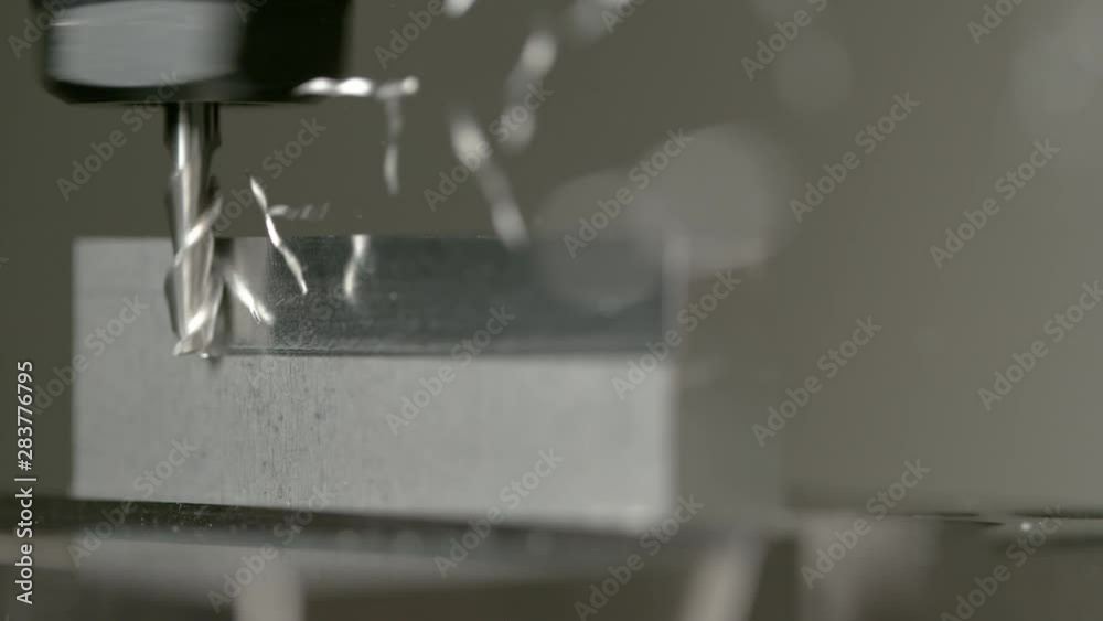 SLOW MOTION, MACRO, DOF: Twisted pieces of excess metal fly off a piece ...