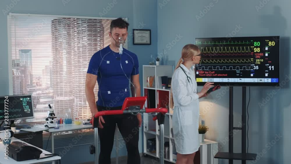 Sports Laboratory: Cardio respiratory test: cardiologist with tablet ...