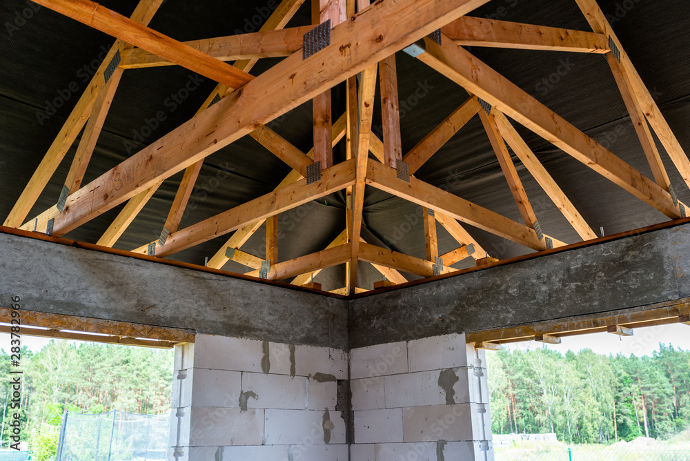 Roof trusses covered with a membrane on a detached house under ...