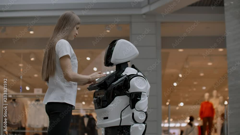 The robot looks at the girl. Artificial intelligence. Modern robotic ...