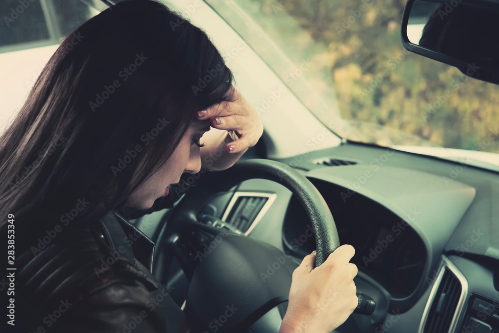 Woman driver feeling anxiety behind the wheel. Close up of crying girl ...