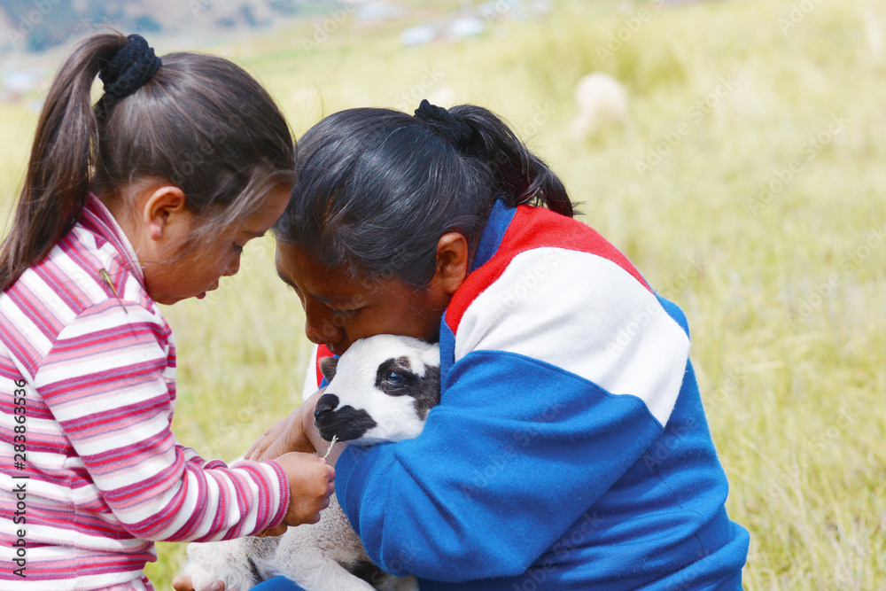 indigenous South American woman with her little daughter taking care of ...