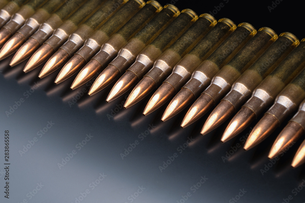 Bullet isolated on black background with reflexion. Rifle bullets close ...