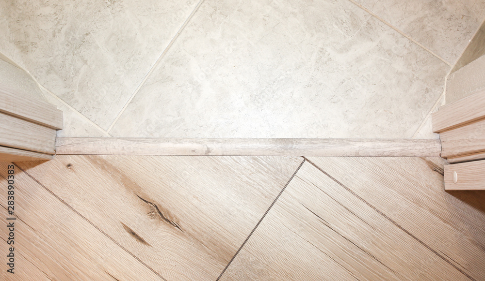 Installation of threshold indoors. Renovation works in the flat. Stock ...