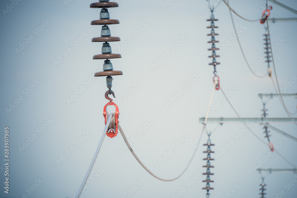 Construction process install aluminum electrical wires with insulators ...