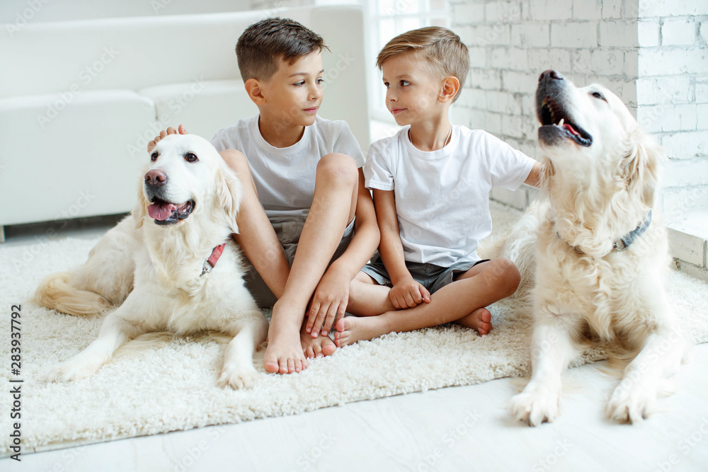 Children with a dog. Happy family with a dog to themselves at home ...