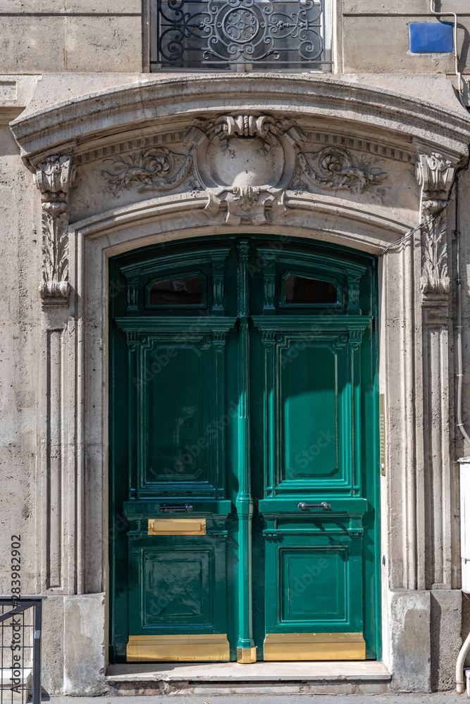 Classical architecture entrance with door painted in bright green color ...