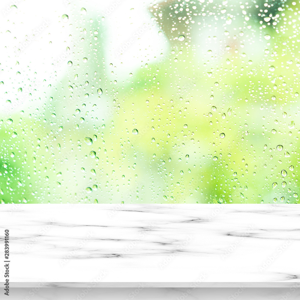 abstract water drop on window glass view of blur green park in square ...