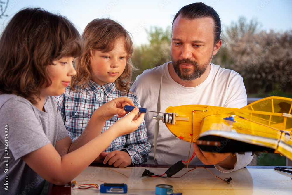 son and father made homemade radio-controlled model aircraft (airplane ...
