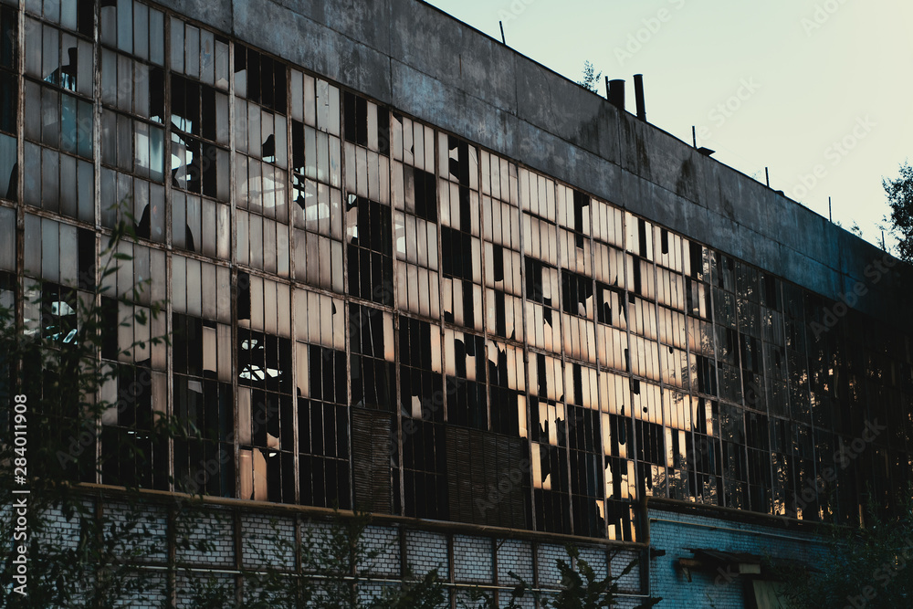 Broken glass windows wall in abandoned ruined factory building ...