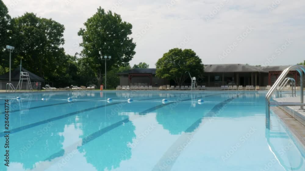 Wide shot of an empty public swimming pool. The outdoor olympic size ...