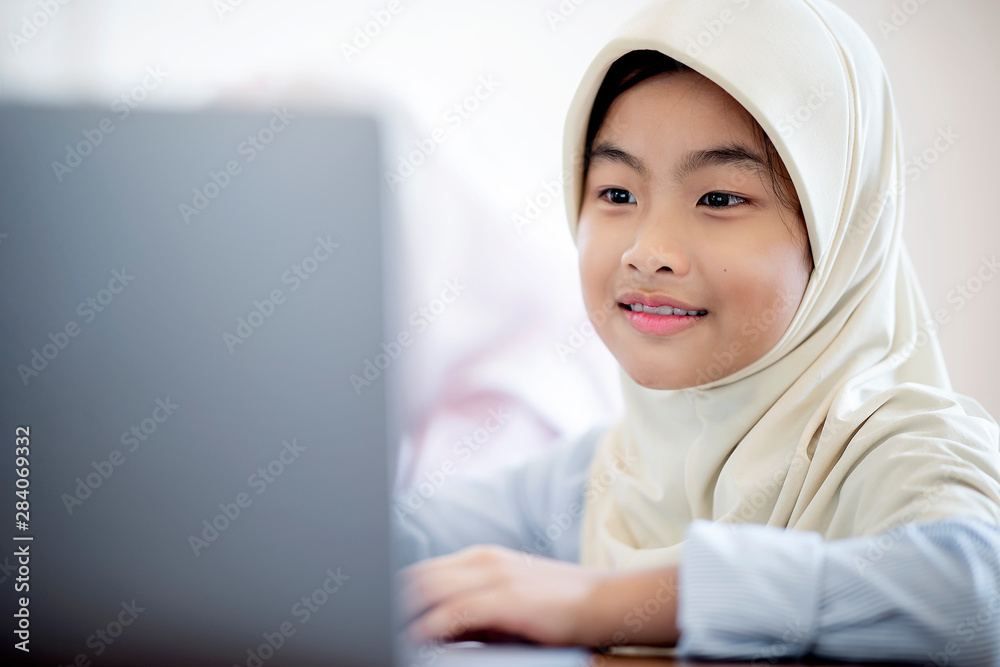 Muslim girl student using laptop and studying in classroom. Stock Photo ...