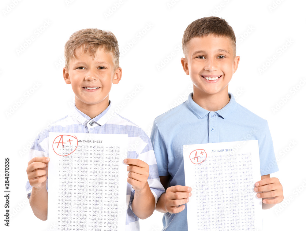 Happy children with answer sheets for school test on white background ...