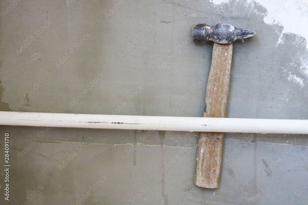Old hammer behind the pipe. Abstract concept symbols in hard work labor ...