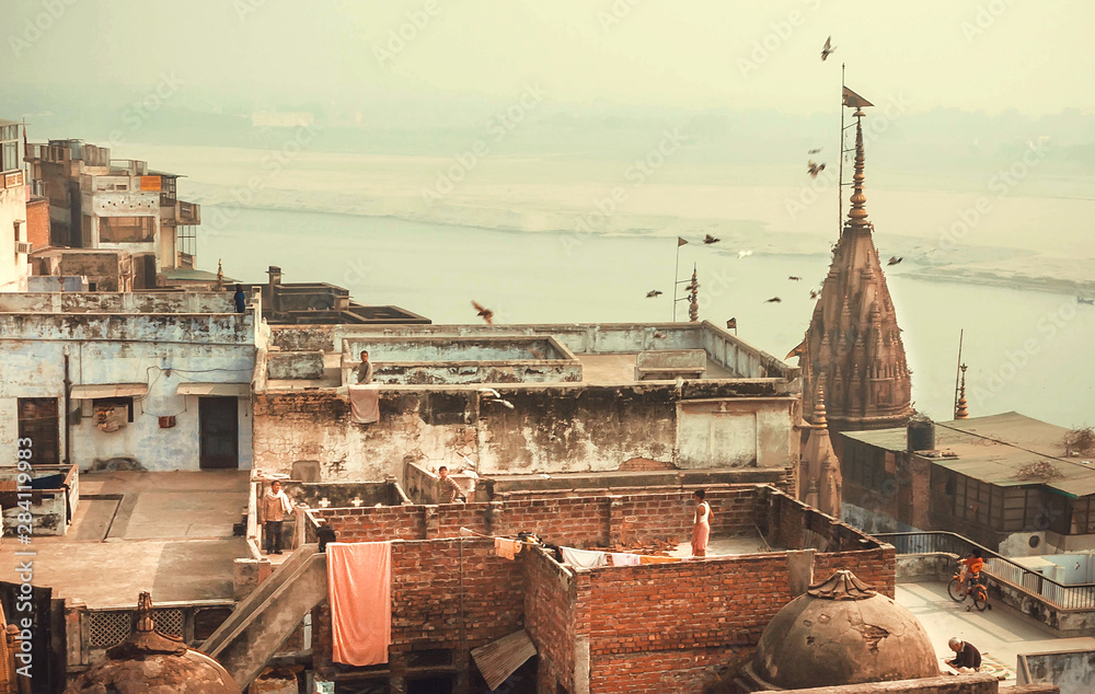 Varanasi city rooftop view with old buildings near Ganges river and ...