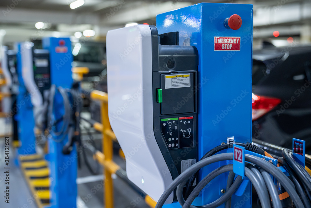 EV Car. Electric car. Charging Station with the power cable plugged in ...