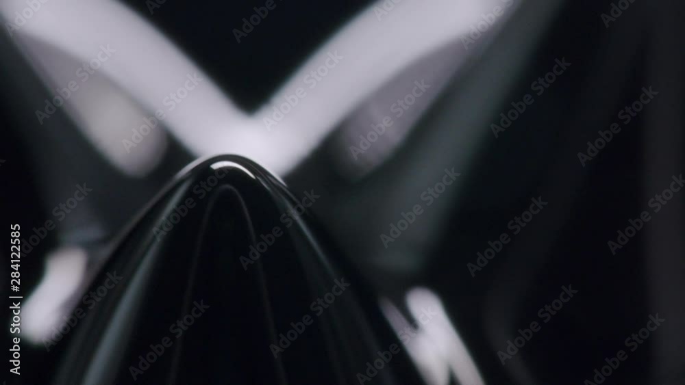 three dimensional pattern of glossy black spikes moving around ...