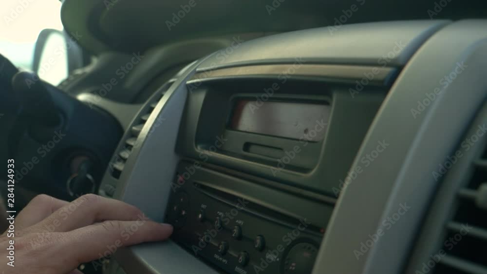 SLOW MOTION, CLOSE UP: Unrecognizable person changing the radio station ...