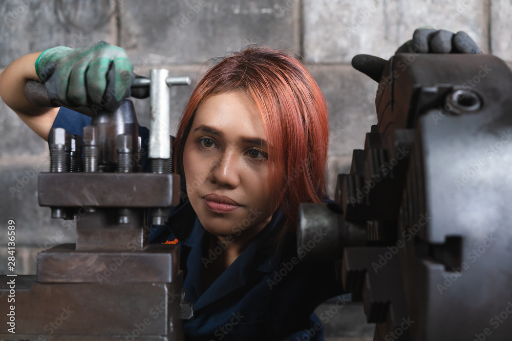 Diverse woman engineer working with heavy industrial machinery - Female ...