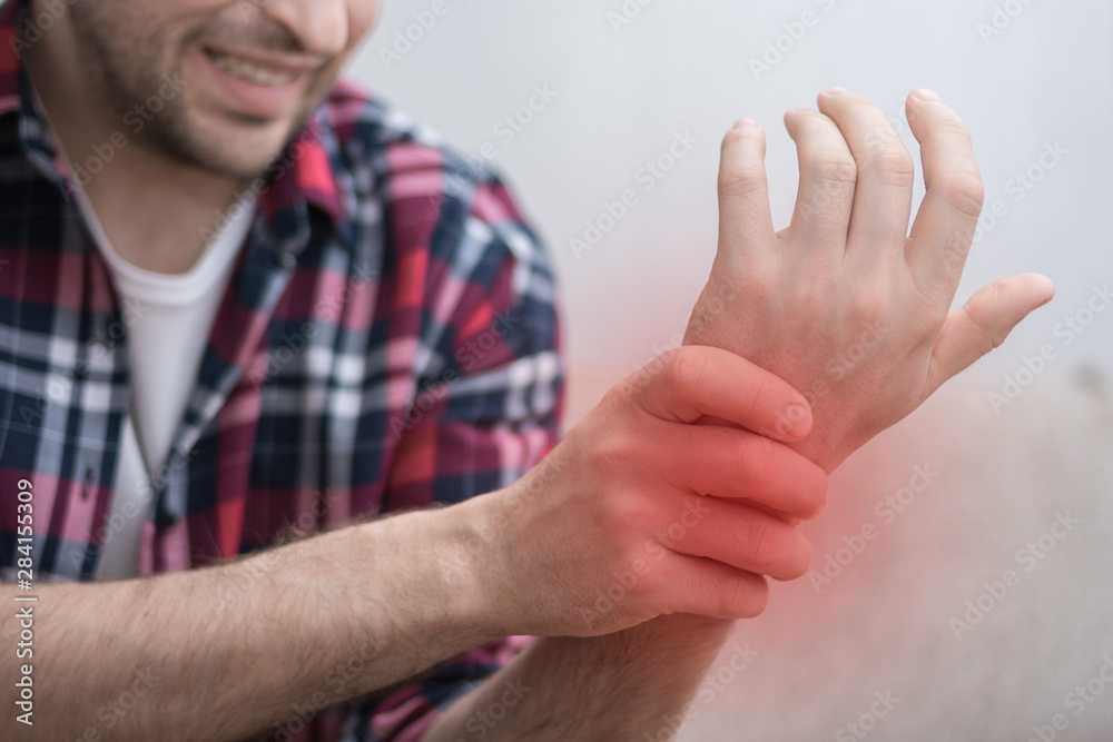 Man feels a sharp pain in their arm, grimace from pain, close up Stock ...